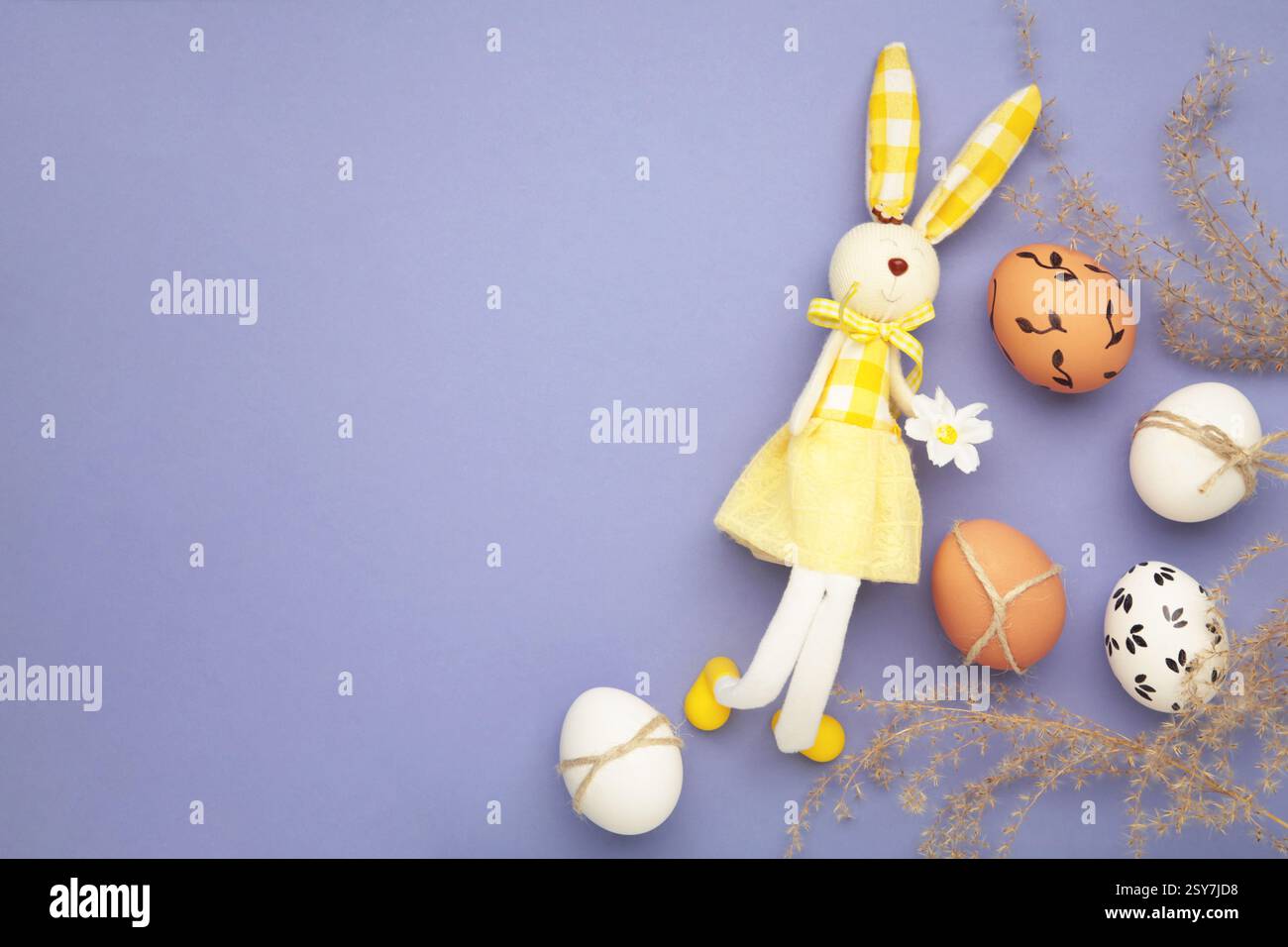 Creative composition with cute Easter bunny rabbit and egg on purple ...