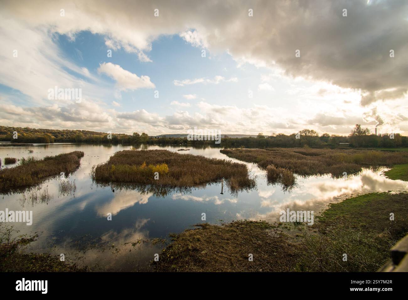 Landscape over a marsh with reflection on water at the Attenborough ...