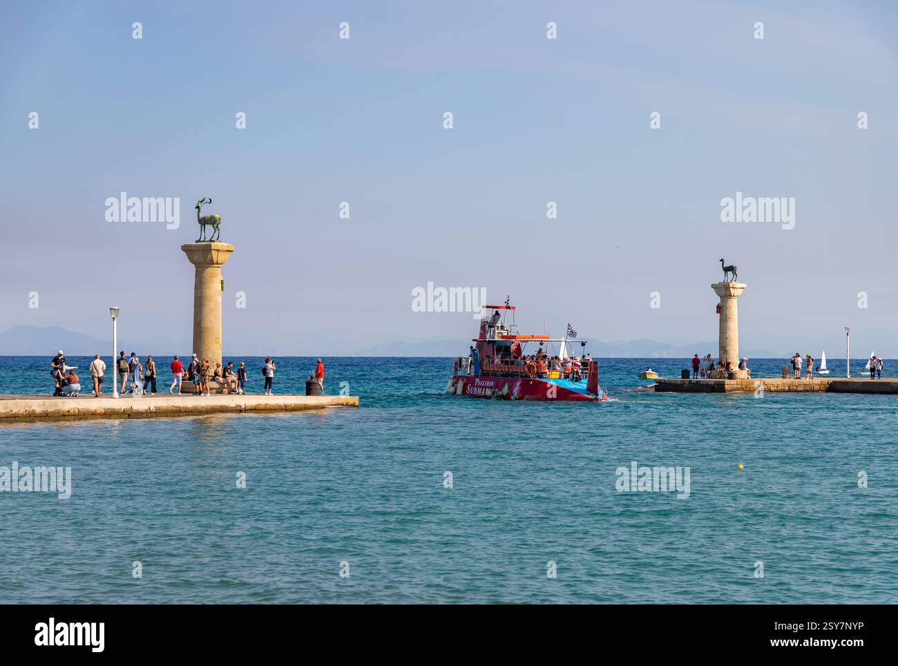 A picture of the Colossus of Rhodes - Deer and Doe Statues, while a red ...