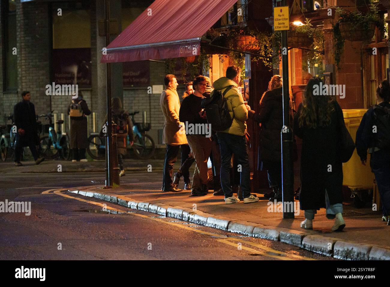 After-work drinkers gathering outside the Fox pub in Shoreditch, on ...