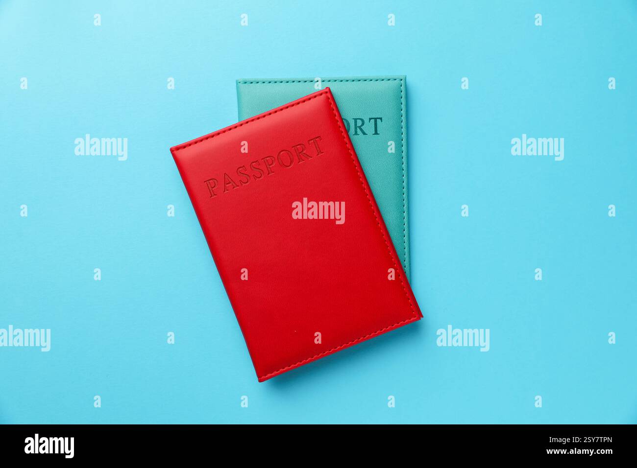 Passports in color covers on light blue background, top view Stock ...