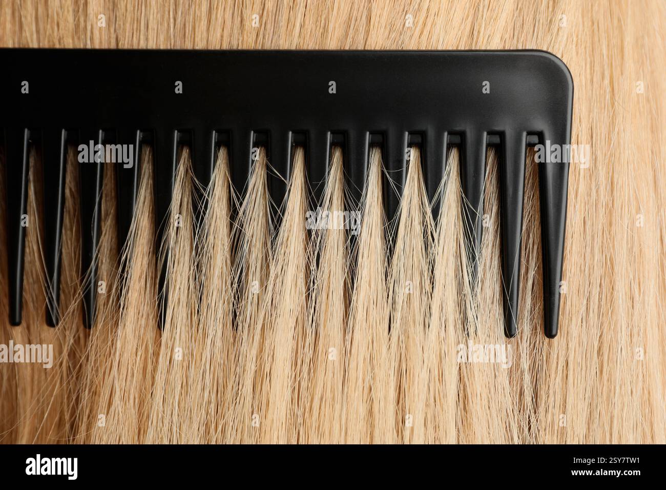 Brushing hair with plastic comb, closeup view Stock Photo - Alamy