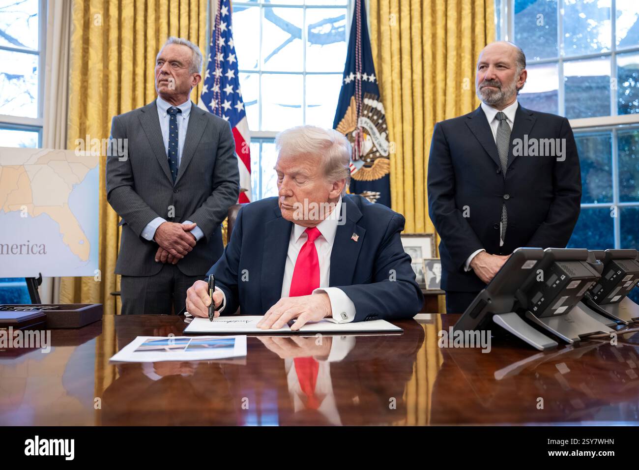 President Donald Trump signs executive orders in the Oval Office ...