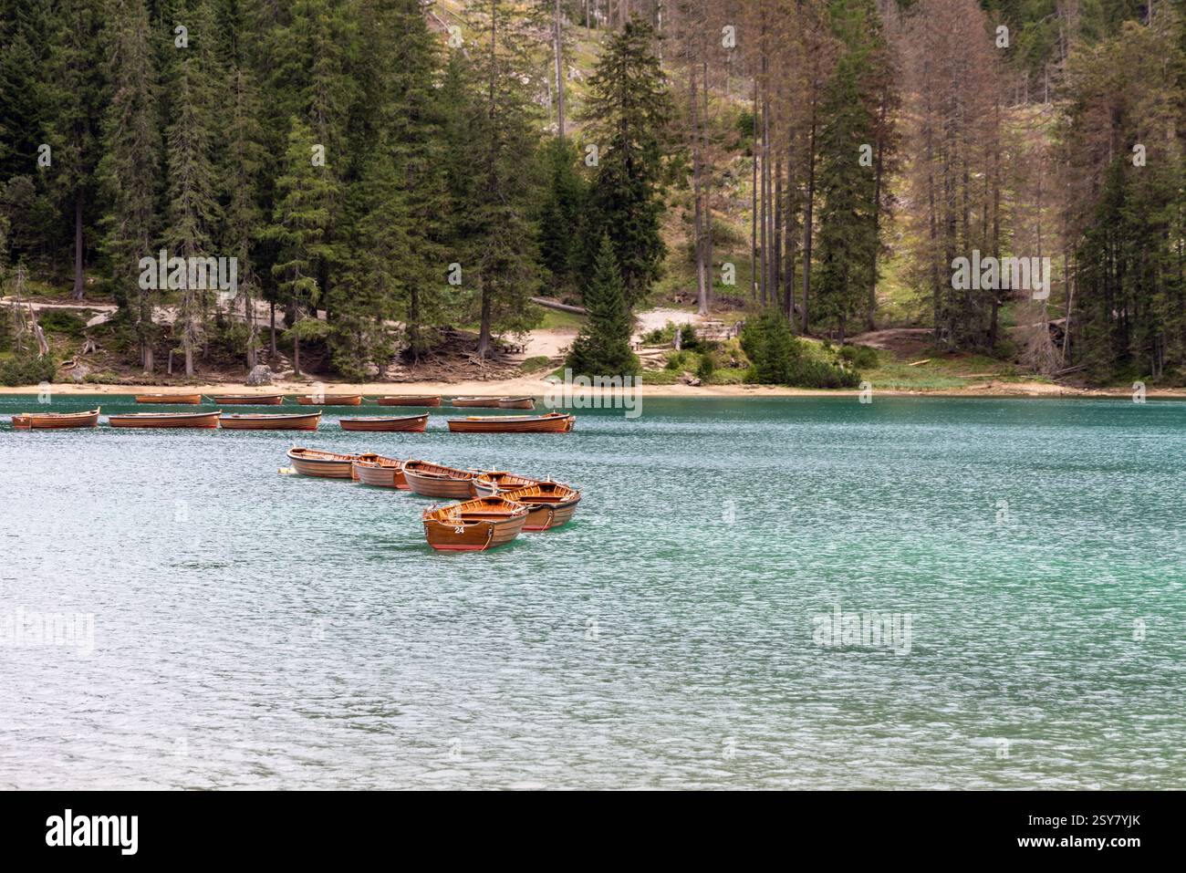 Traditional wooden boats float on the turquoise waters of Lake Braies ...
