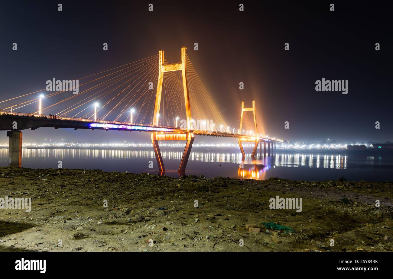 modern architectural bridge glowing over ganges river in night lights ...