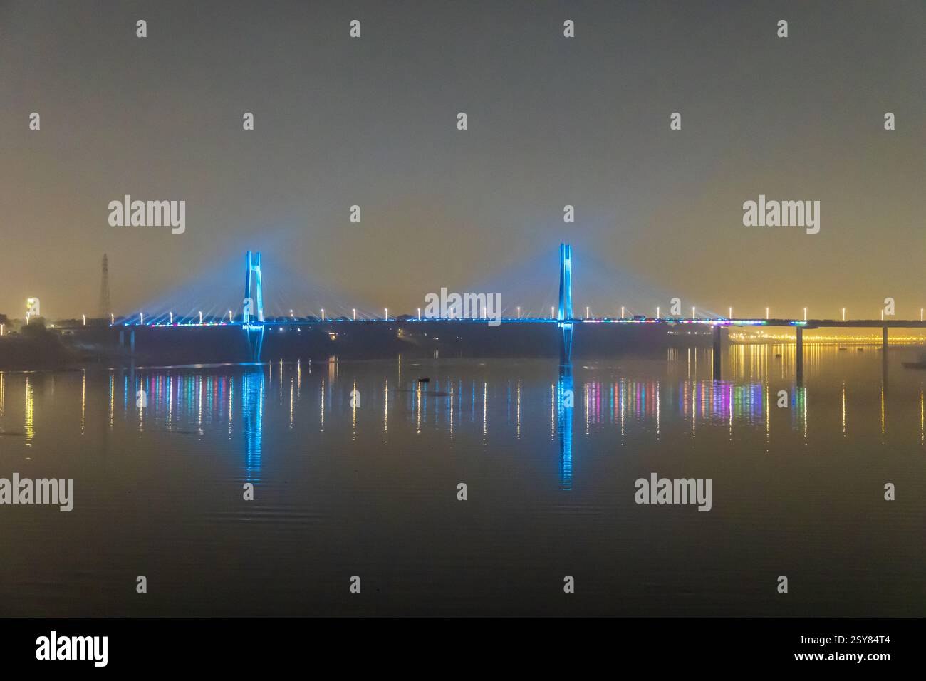 modern architectural bridge glowing over ganges river in night lights ...