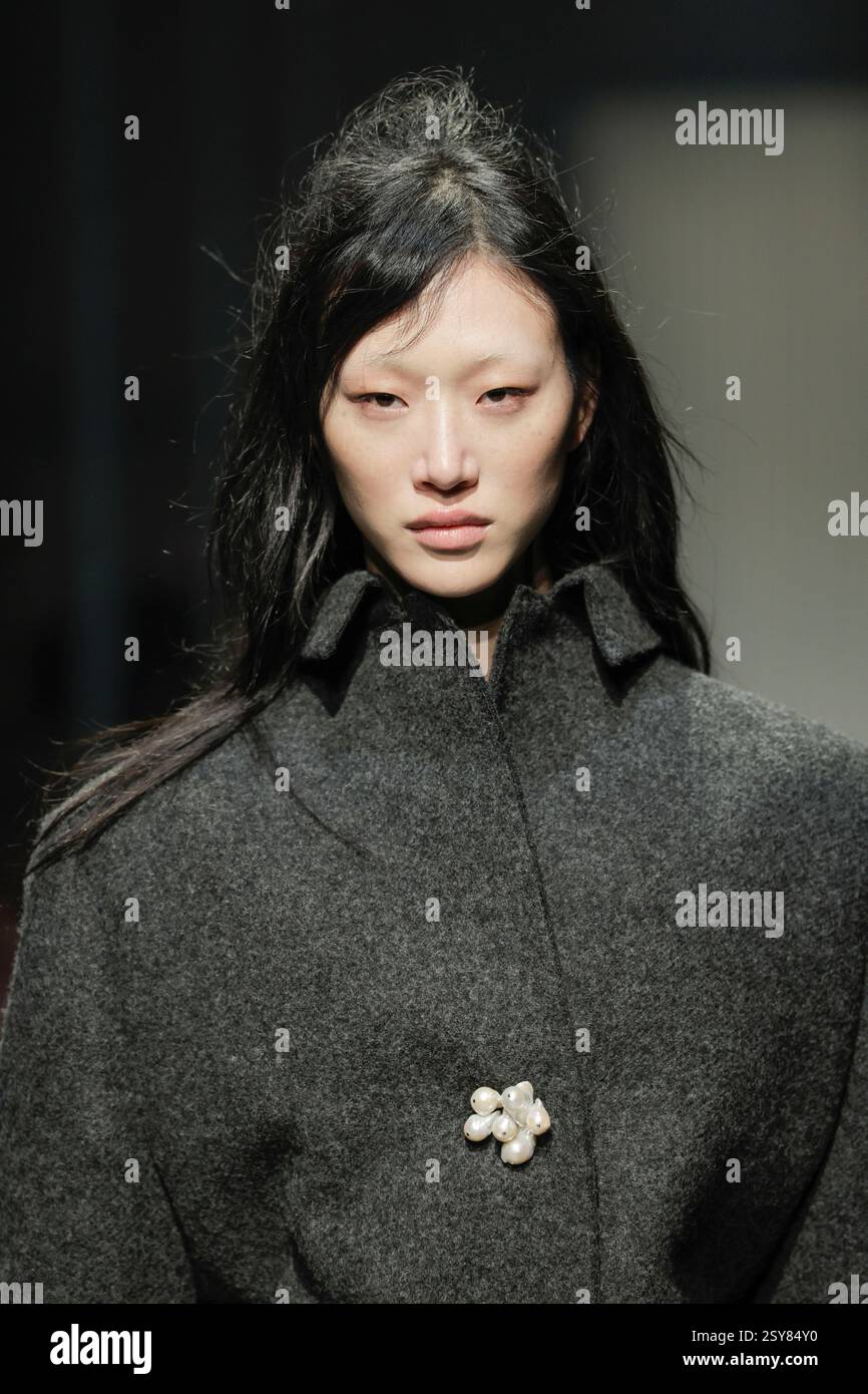 Milan, Italy. 27th Feb, 2025. Model Sora Choi walks on the runway ...