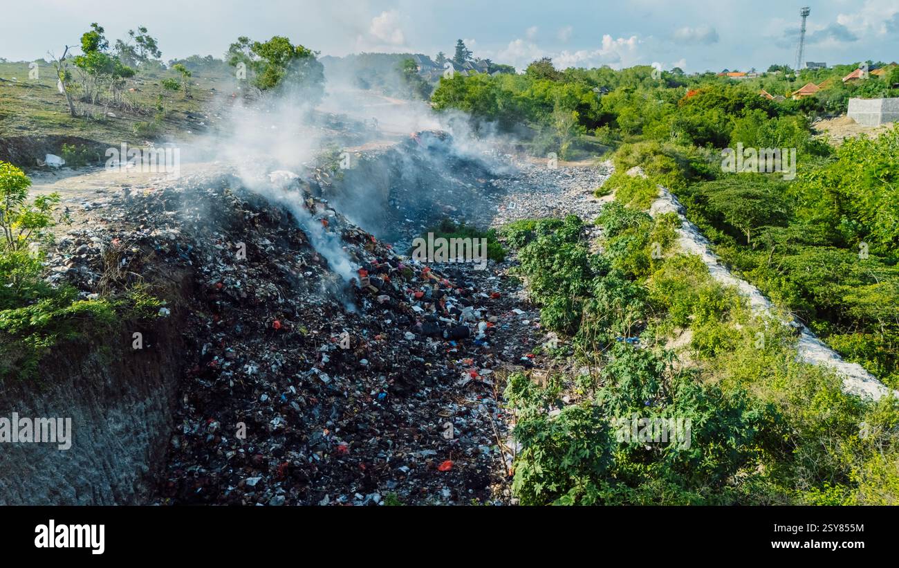 Burning dump in Bukit, Bali. drone view. Pollution by plastic rubbish ...