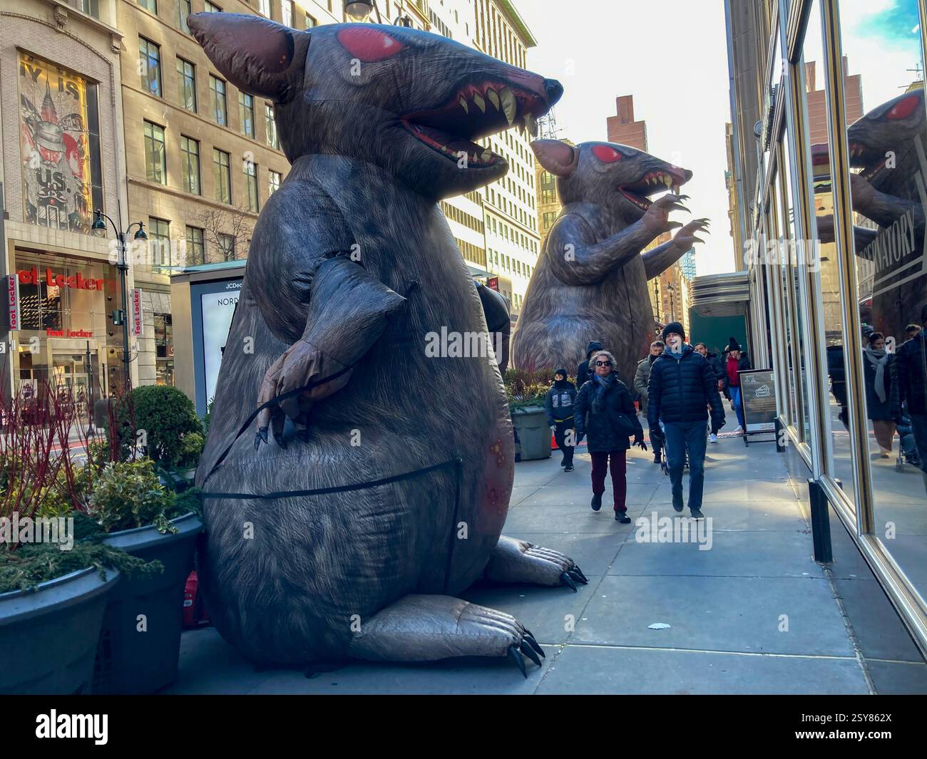 A collection of inflatable union rats outside the Empire State Building ...