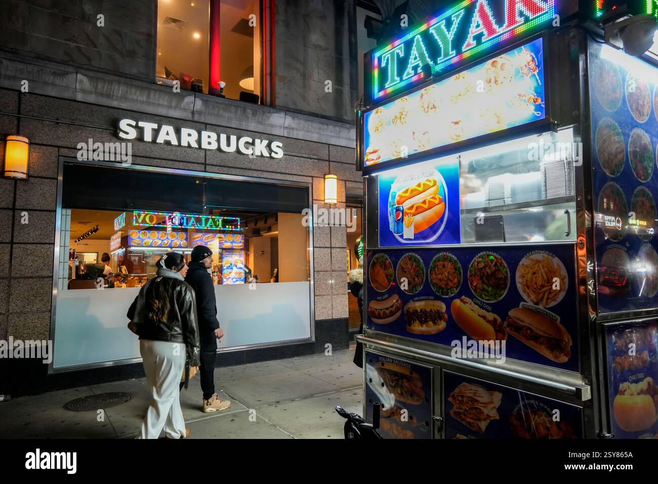 A Starbucks and a food cart in Midtown Manhattan in New York on ...