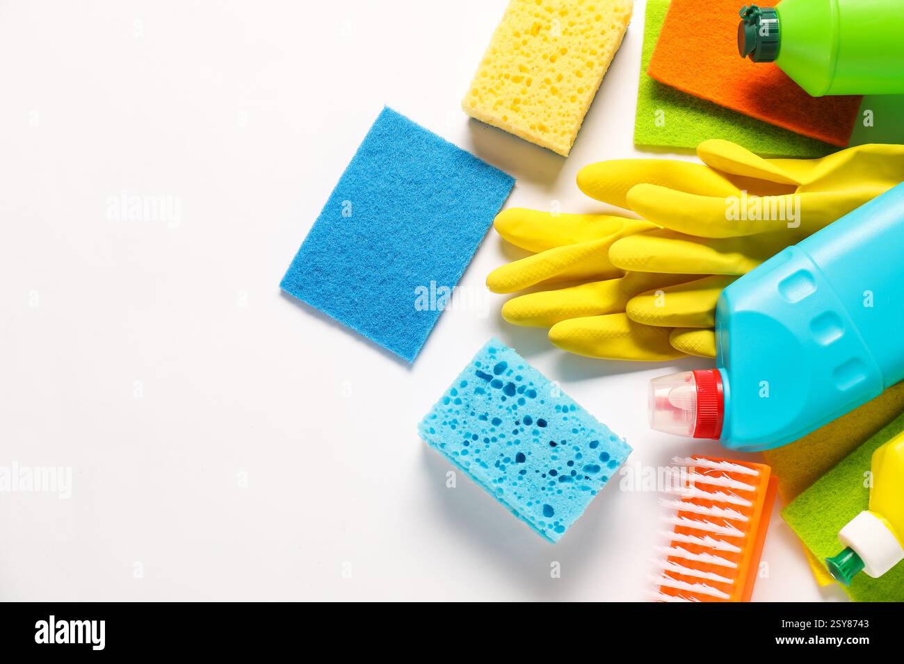 Different cleaning products and tools on white background, flat lay ...