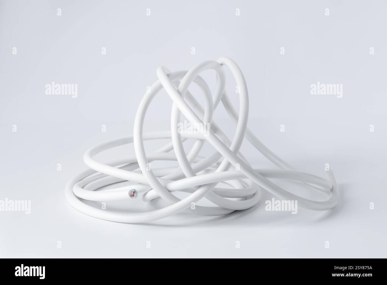 Tangled insulated electrical wire isolated on white Stock Photo - Alamy