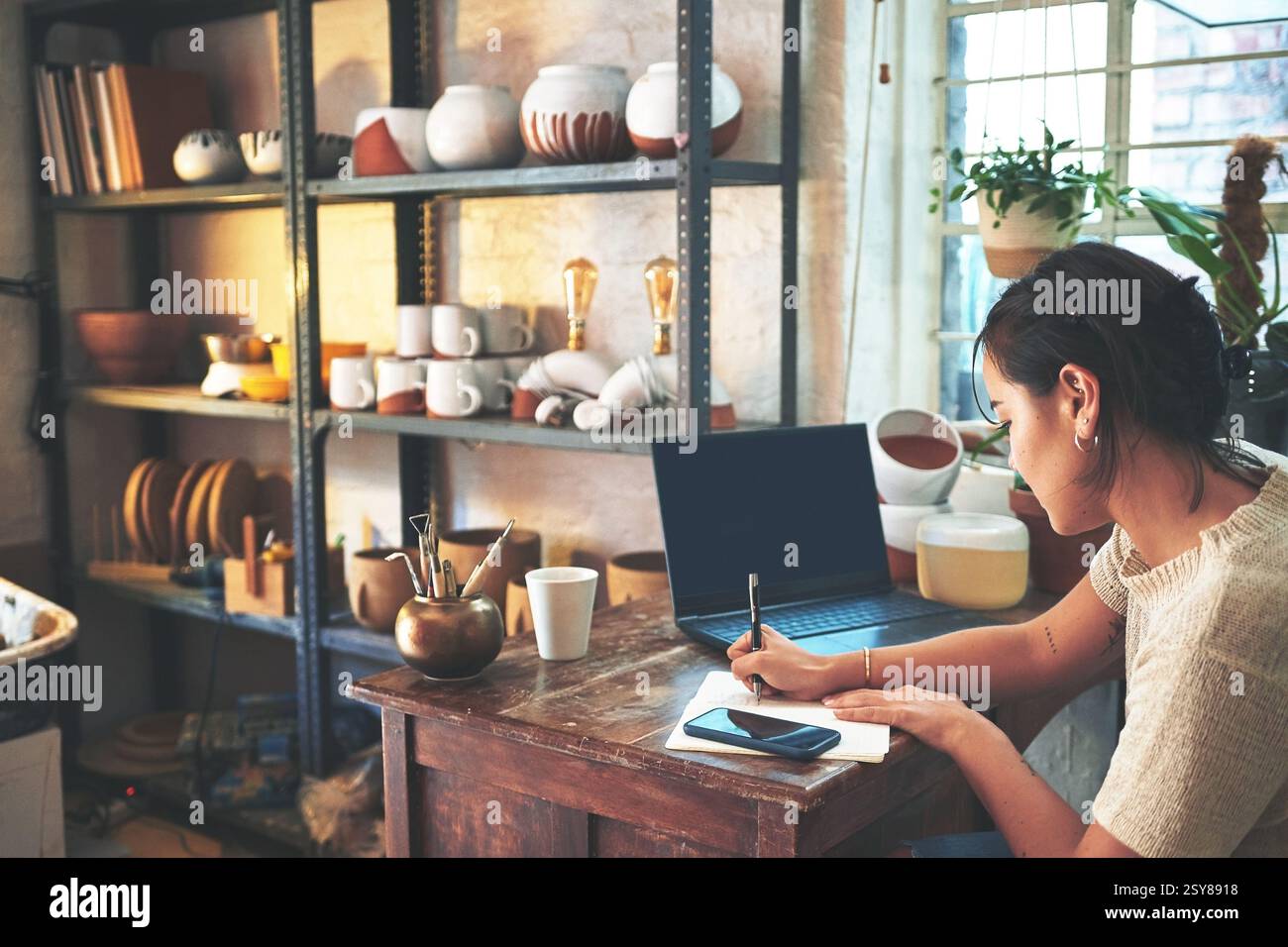 Notebook, writing and pottery with woman in studio for ceramic ...