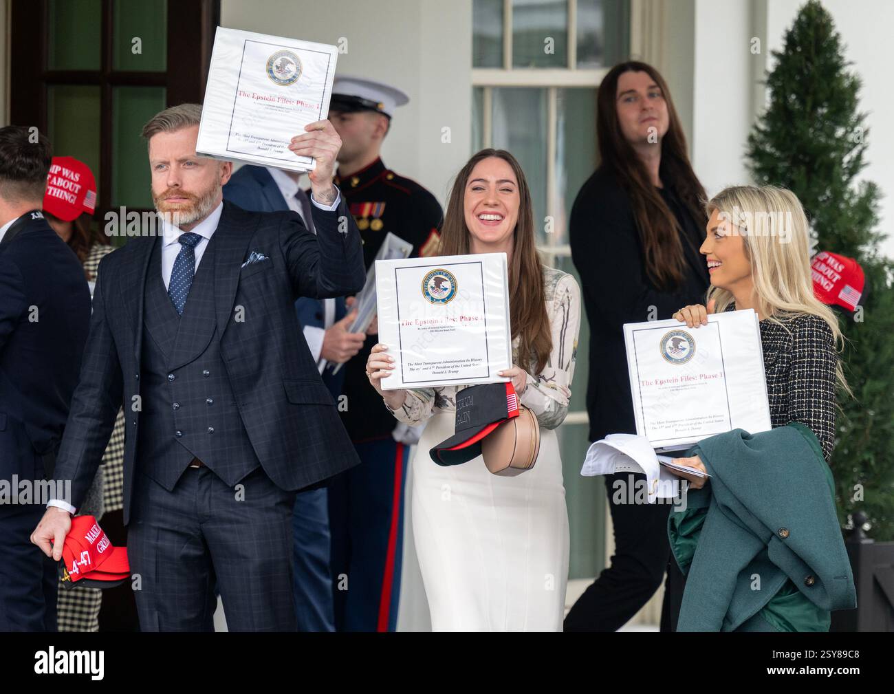 Unidentified people hold binders with information on the Epstein Files ...