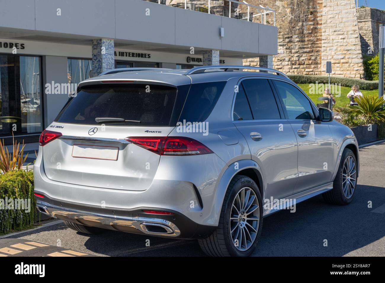 Modern silver mercedes benz gle suv parked near commercial building ...