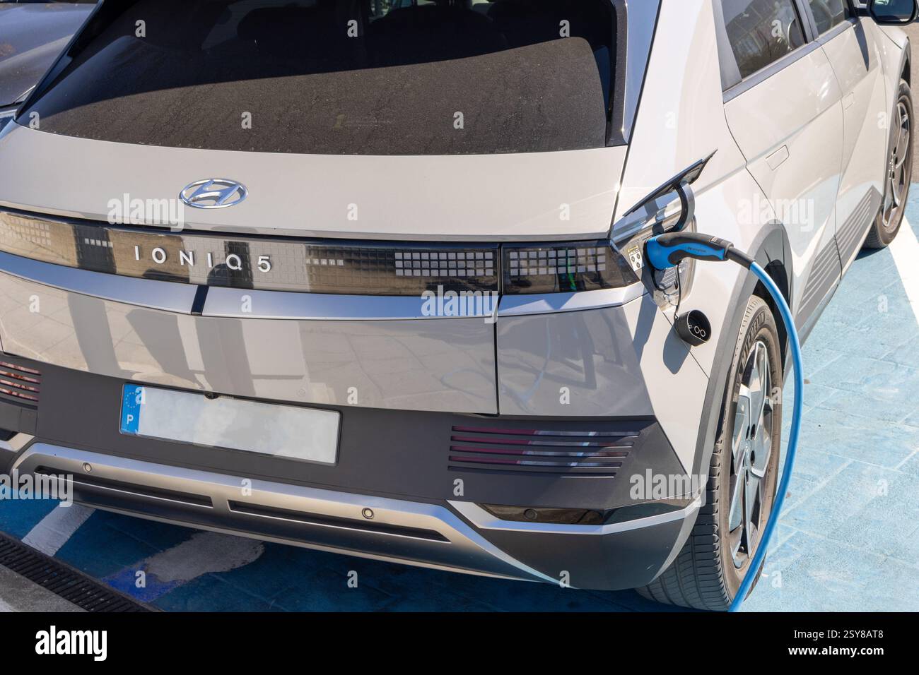 Close up of a hyundai ioniq 5 electric car charging its battery at a ...