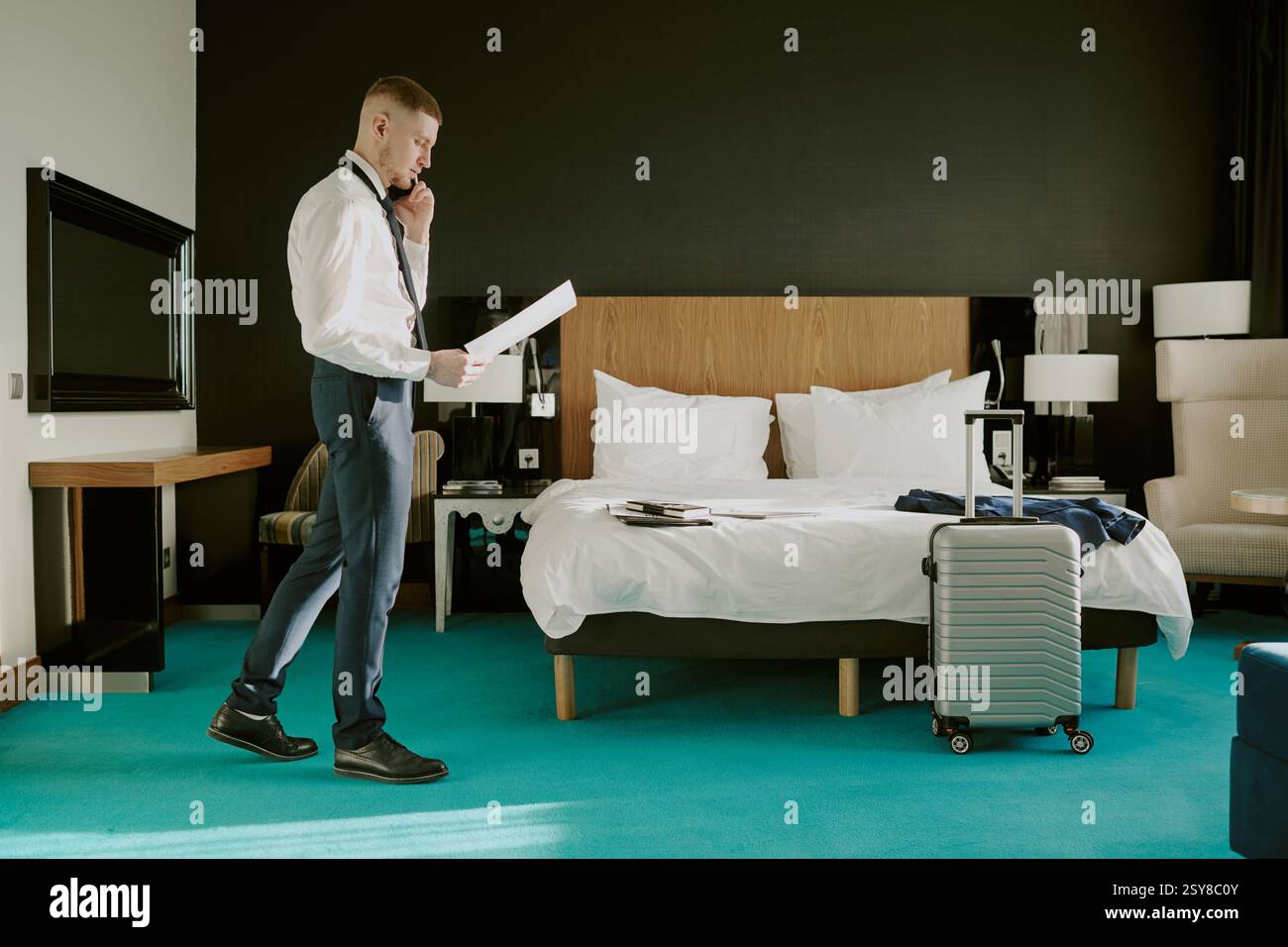 Wide shot of walking young man holding menu and having conversation ...