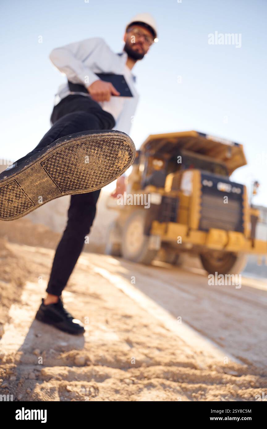 Having fun, making a kick by leg. Man in uniform is working in the ...