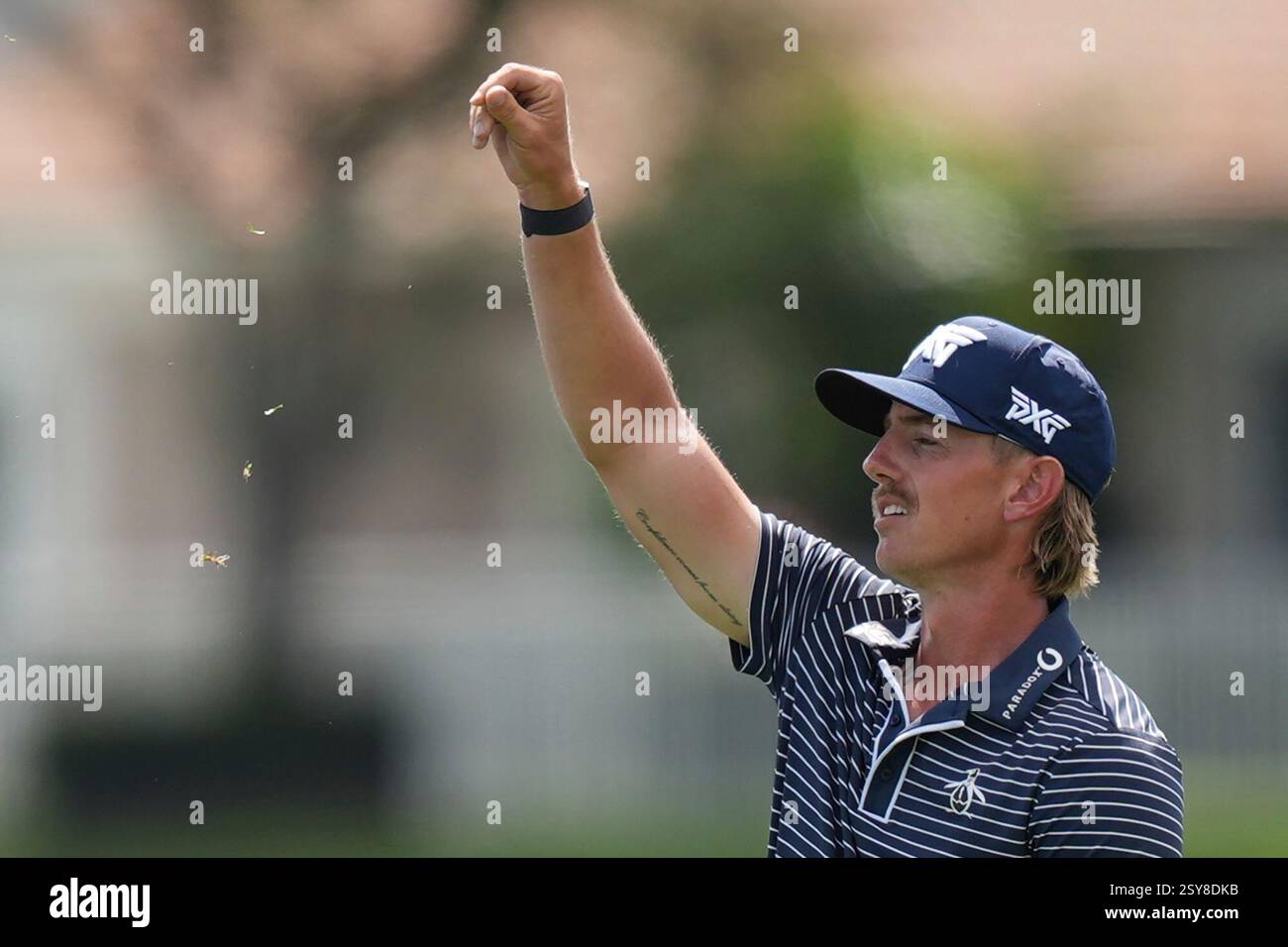 Jake Knapp uses grass to check the wind on the 18th hole during the ...