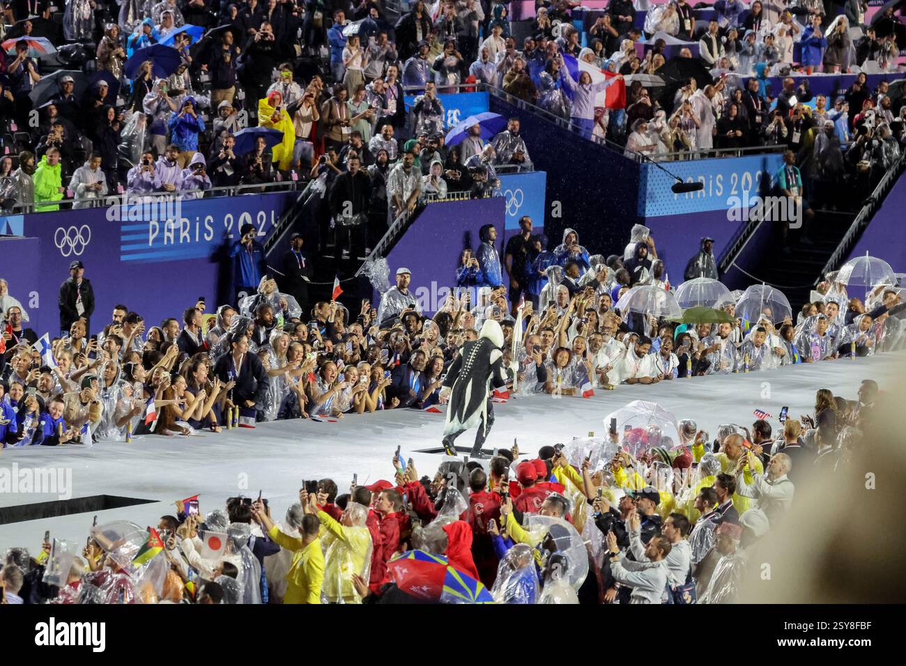 July 26th, 2024 - Paris, France: The masked torchbearer appears at the ...