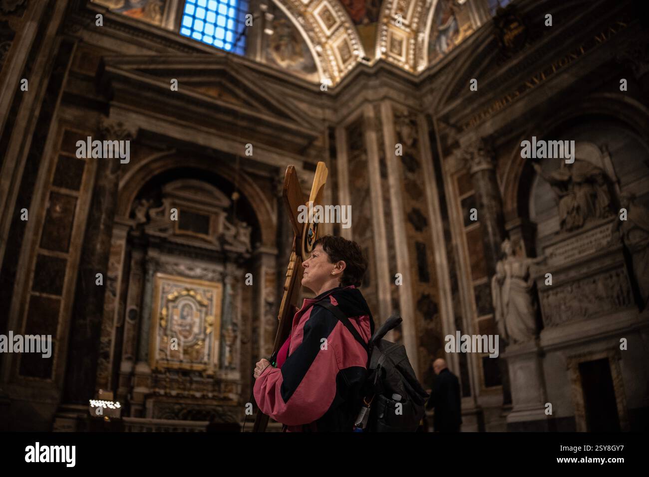 Vatican City, Vatican. 27th Feb, 2025. An American pilgrim carries a ...