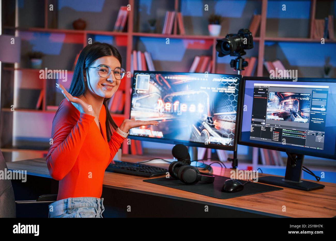 Positive facial expression. Young beautiful game streamer is indoors ...