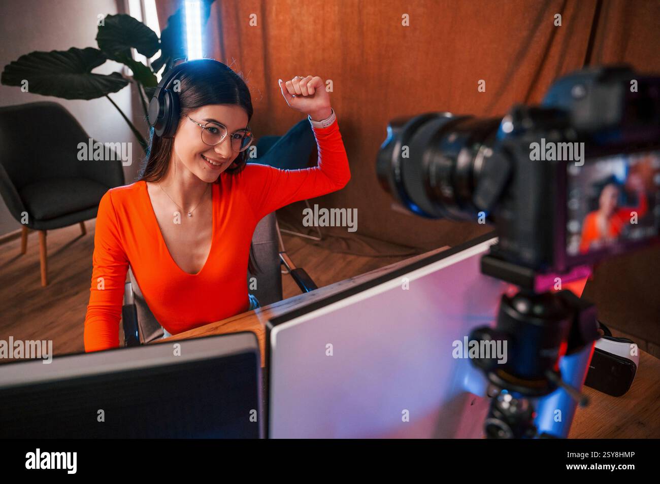 Professional camera is recording the woman. Young beautiful game ...