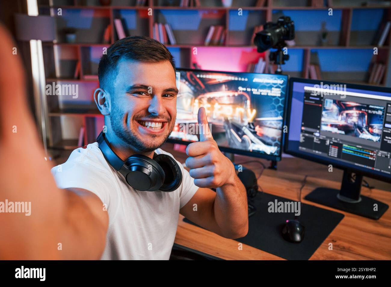 Making selfie, celebrating victory. Male game streamer in casual ...