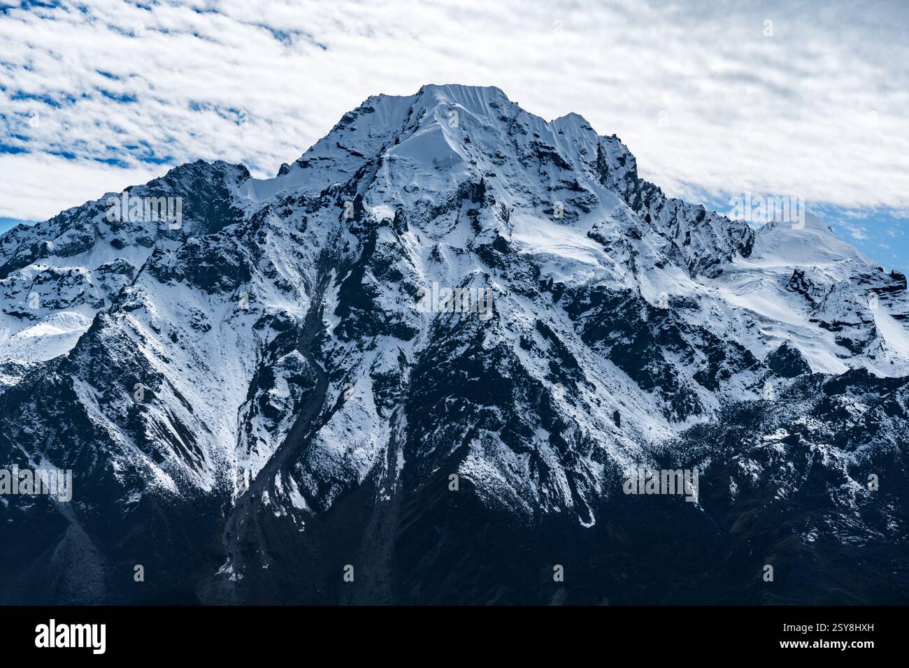 Beautiful Snow Capped Mountains with cloudy blue skies in the Himalayas ...
