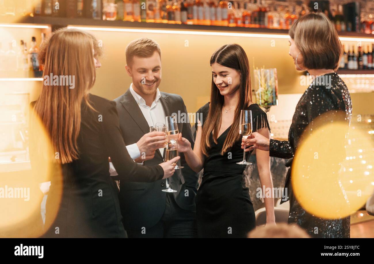 Group of people in elegant clothes are in the restaurant celebrating ...