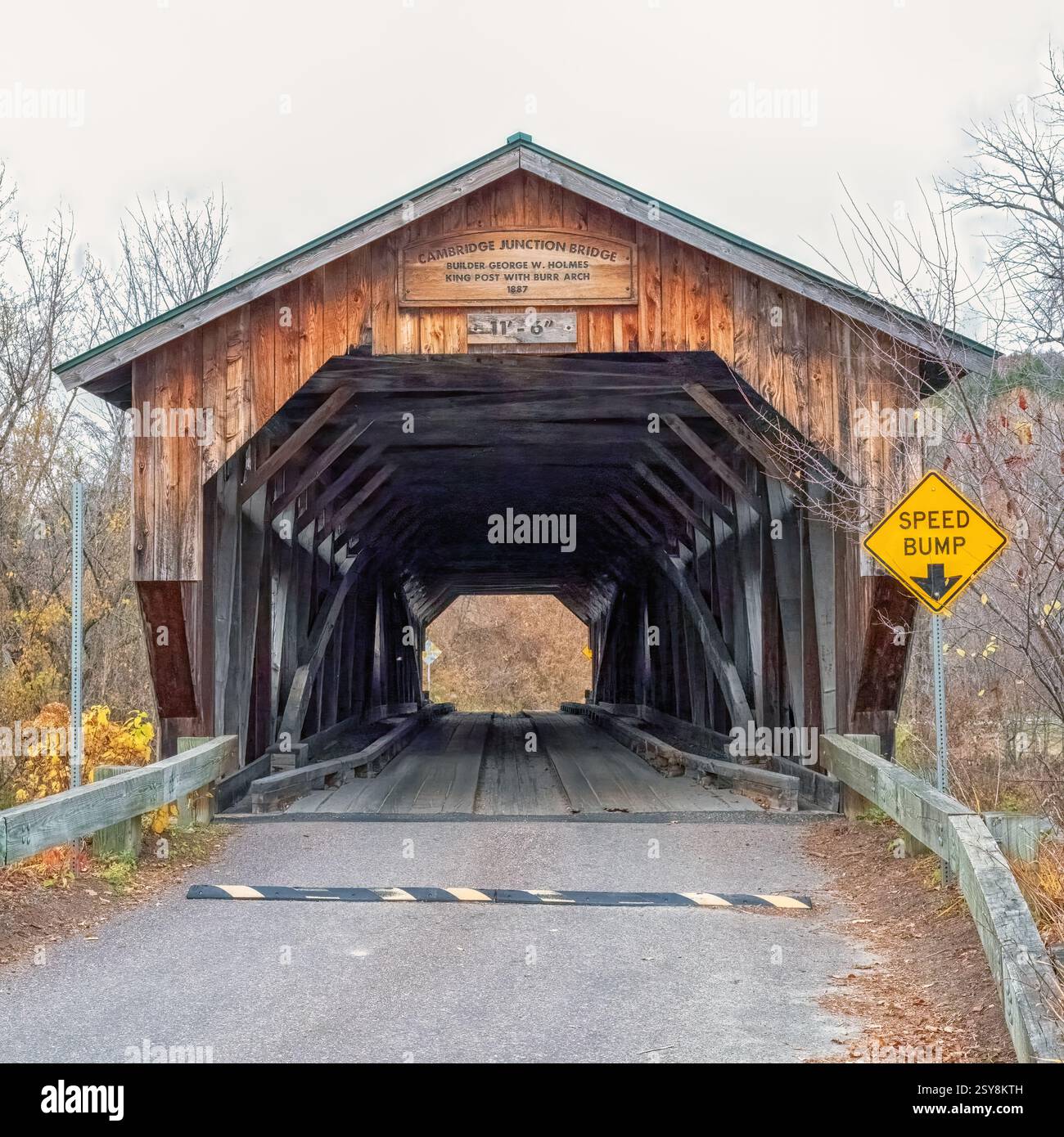 Historic wooden covered bridge with speed bump sign in rural Vermont ...