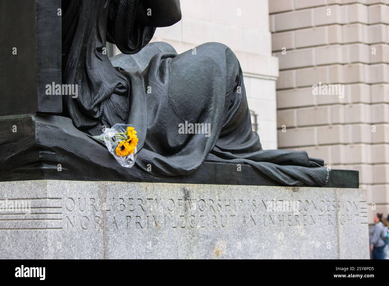 Flowers sit on a statue outside the Ronald Reagan building in ...