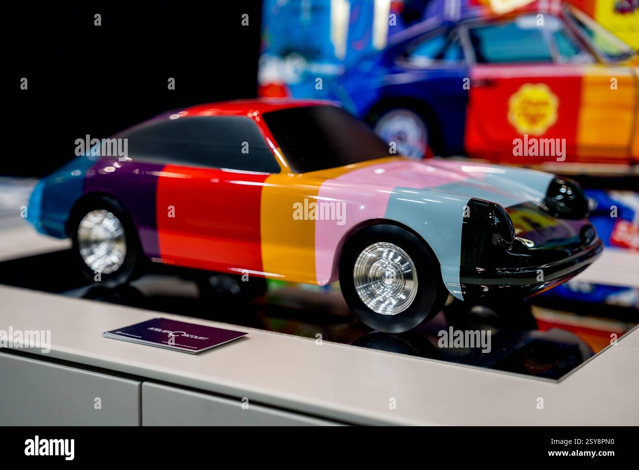 Colorful custom car model showcased at design expo highlighting ...
