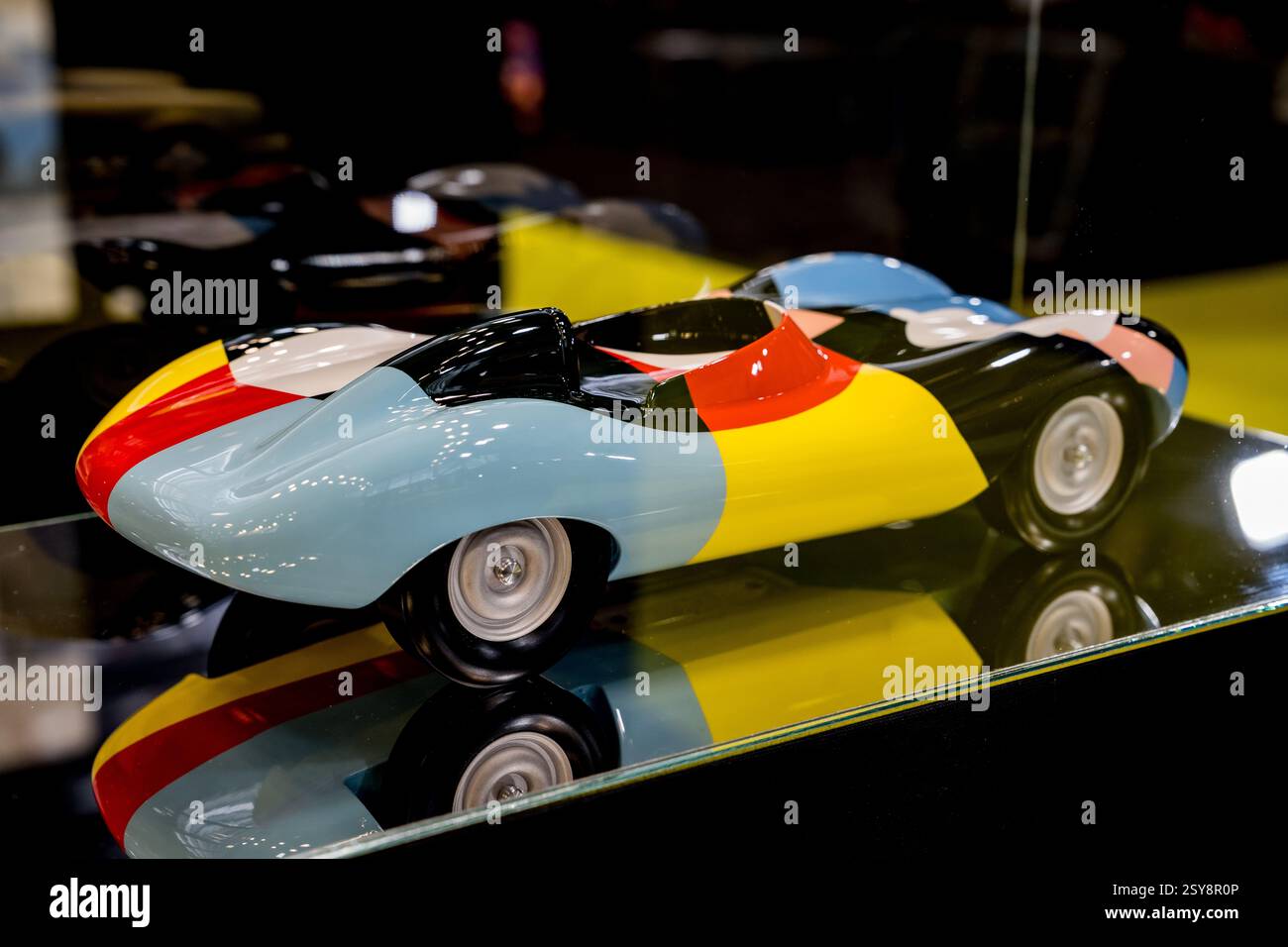 Vibrant vintage racing car model showcasing artistic design in a modern ...