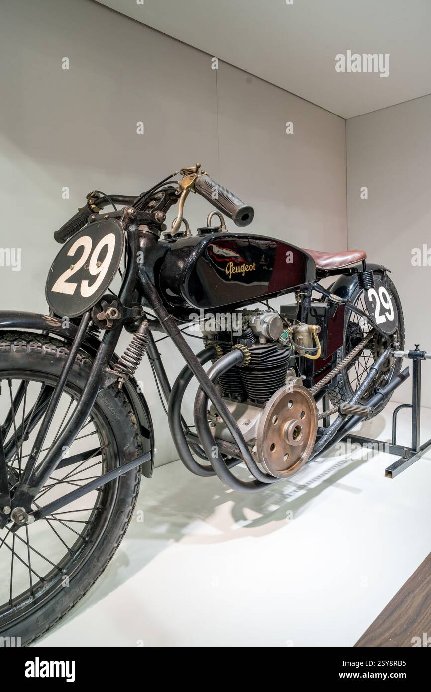Historic racing motorcycle on display in a modern museum, showcasing ...