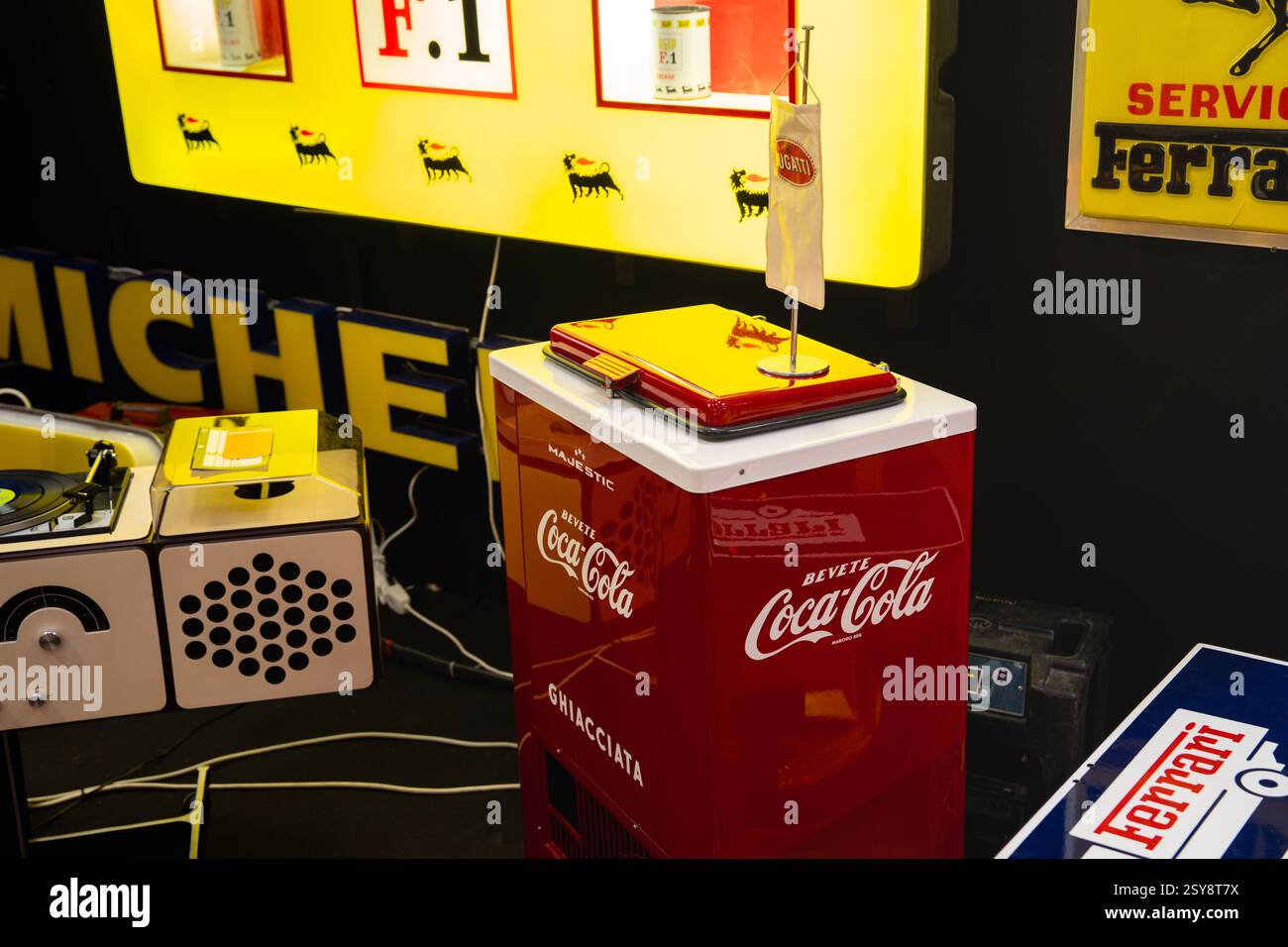 Vintage Coca-Cola vending machine surrounded by retro decor in a lively ...