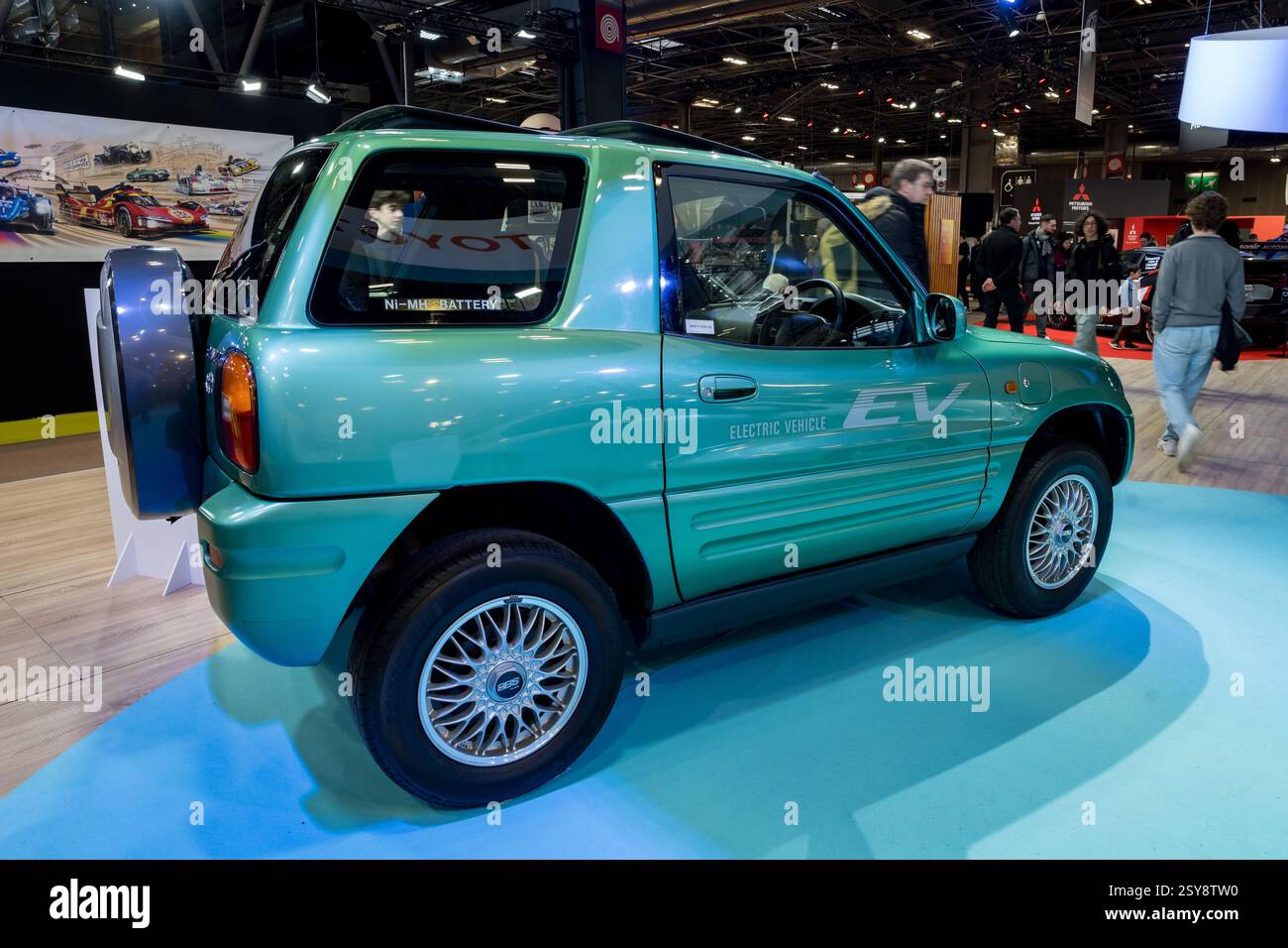 Compact electric vehicle showcases innovative design at a bustling auto ...