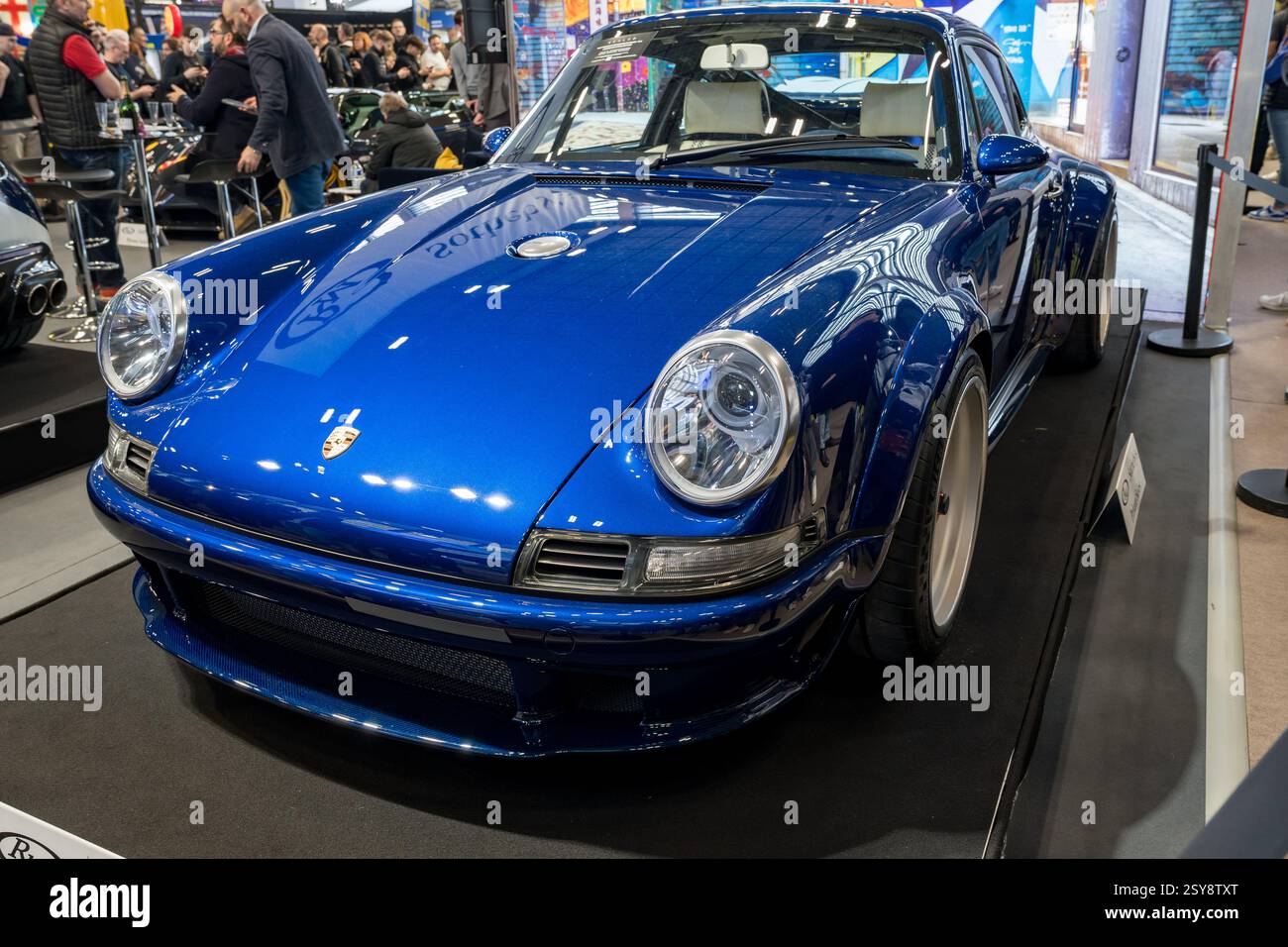 Sleek blue sports car on display at an automotive exhibition showcasing ...