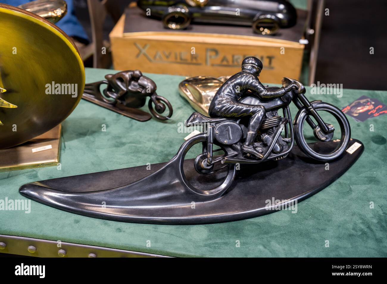 Intricate bronze sculpture of a motorcycle racer captures the thrill of ...
