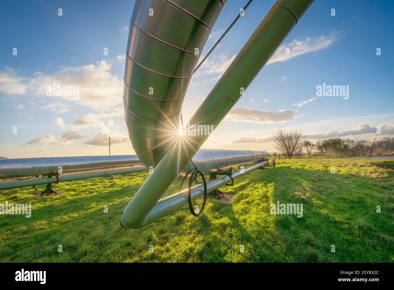 Pipelines of a geothermal power plant at sunset in Larderello, Tuscany ...