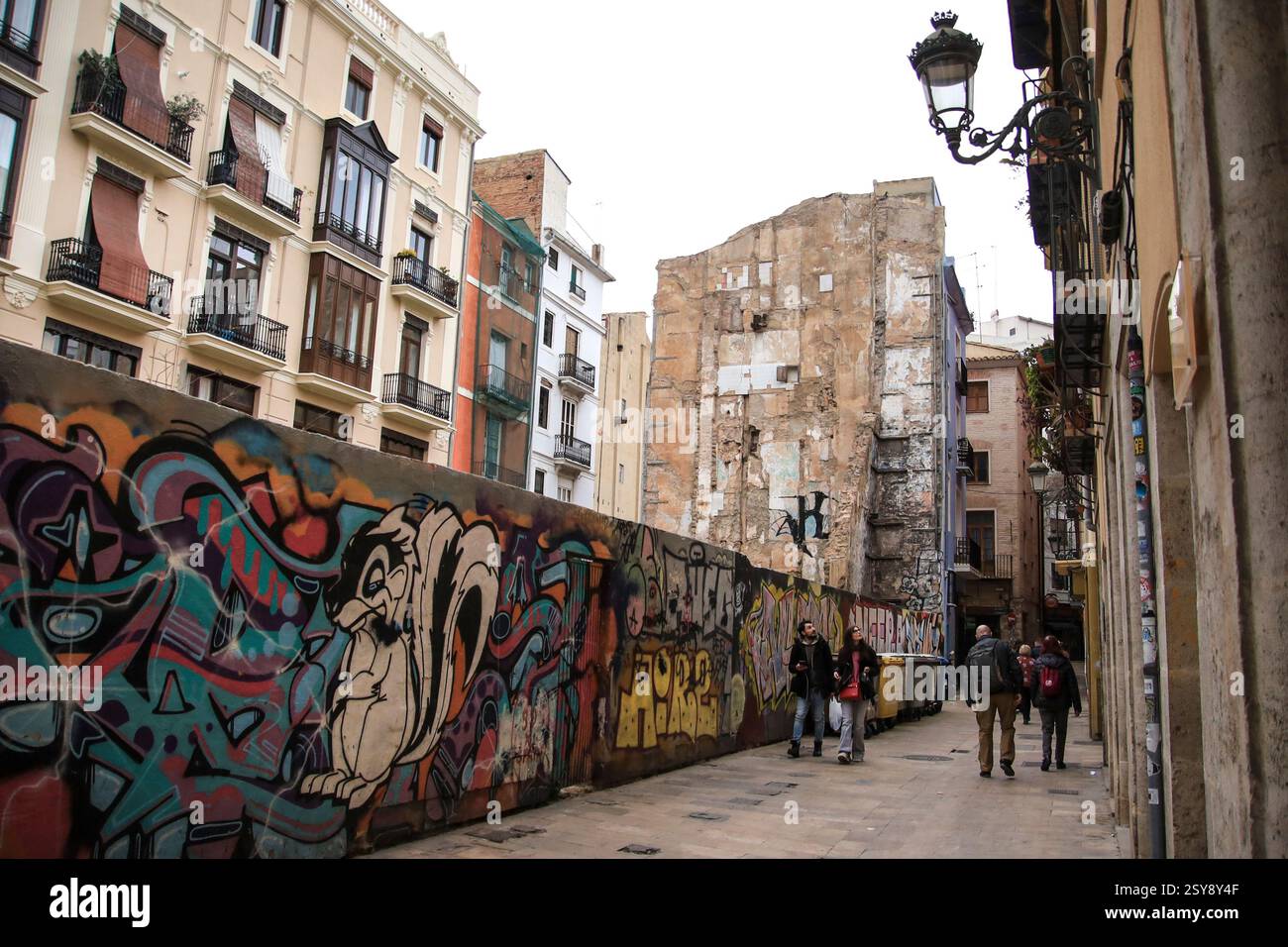 Valencia, Spain- December 26, 2024: Narrow street with old facades in ...