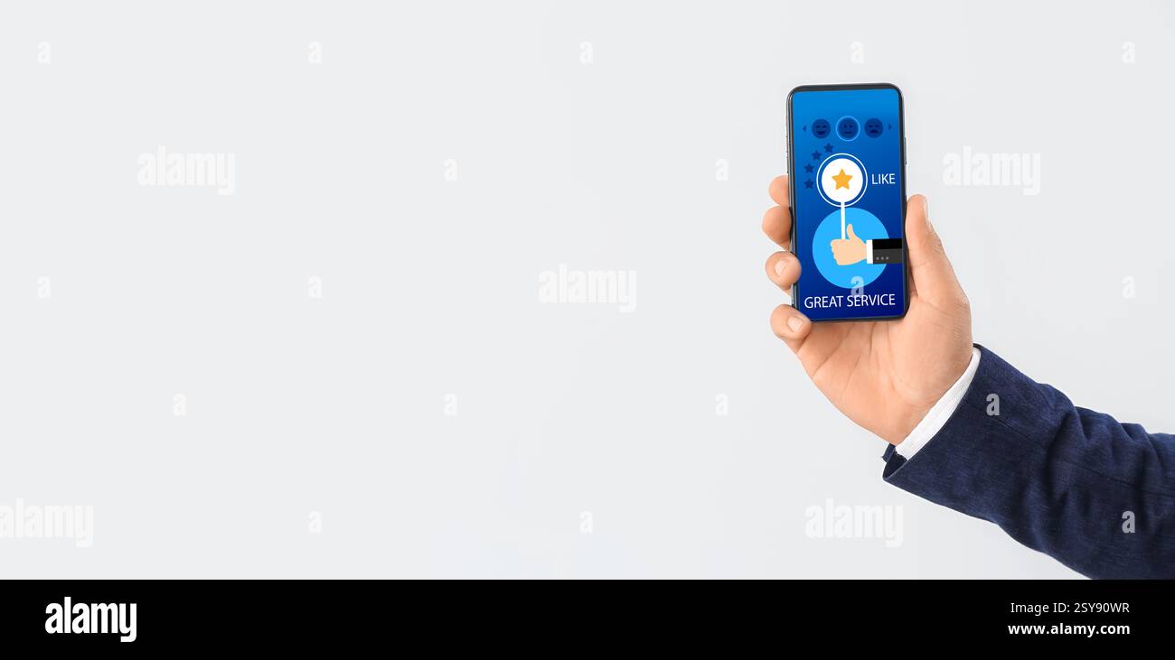 Hand of man with mobile phone responding to survey on light background ...