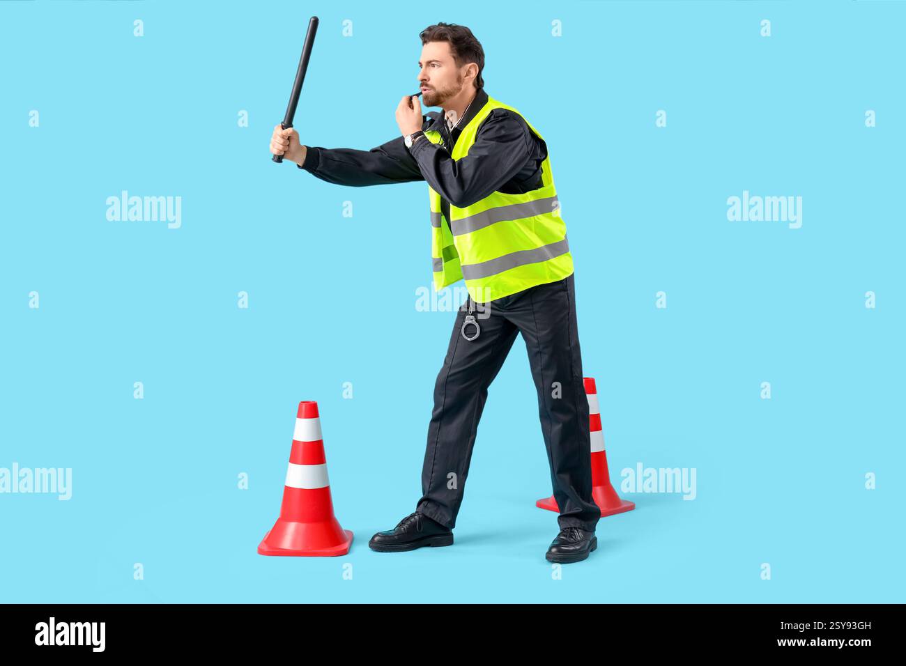 Male police officer with baton, traffic cones and whistle on blue ...