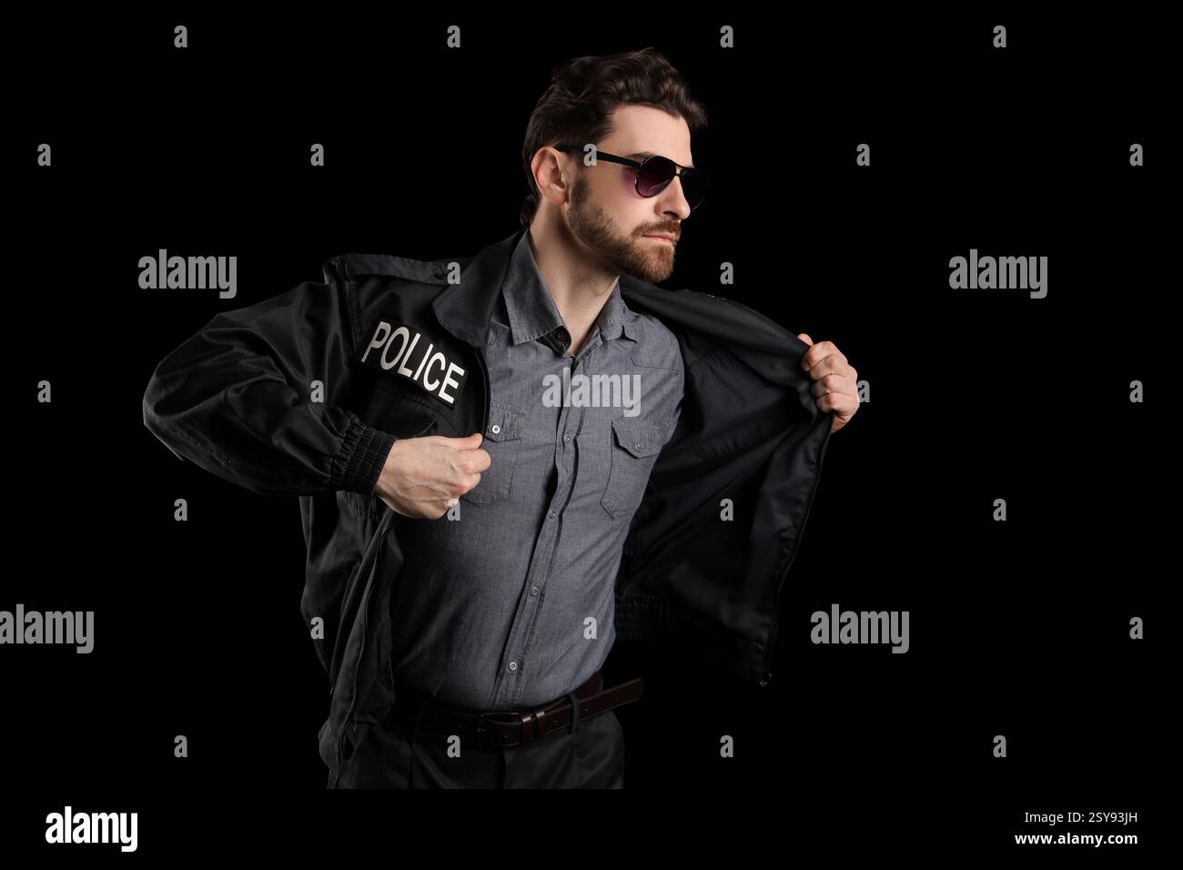 Male police officer on black background Stock Photo - Alamy