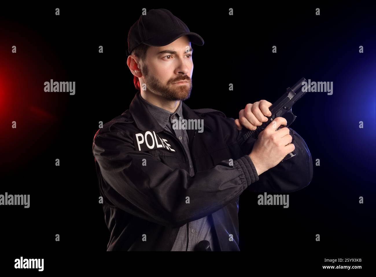 Male police officer with gun against flashing siren lights on black ...