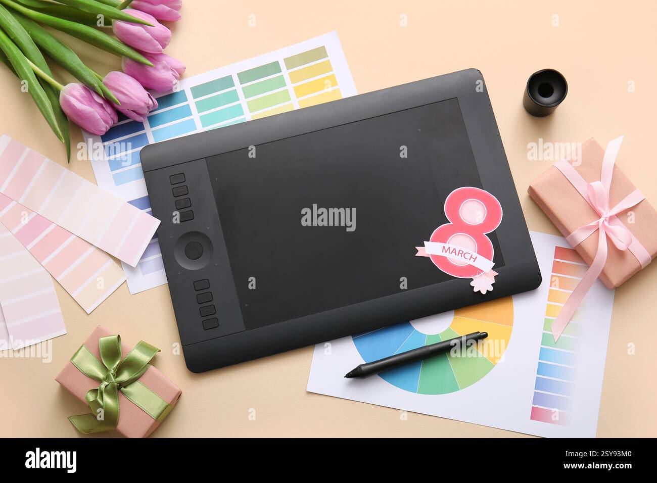 Graphic tablet with color palettes, flowers, gift boxes and paper ...