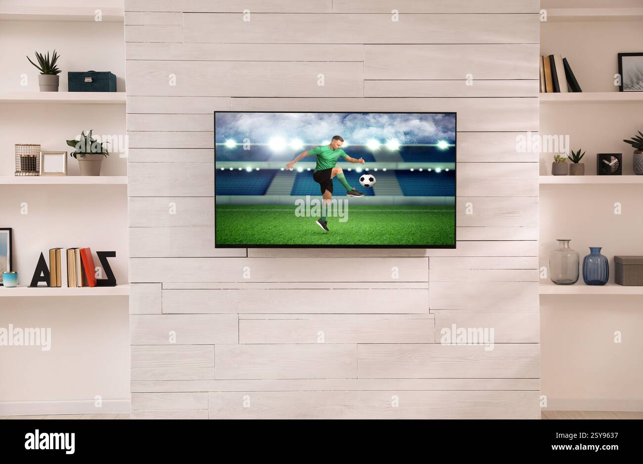 Soccer game playing on TV set in room Stock Photo - Alamy