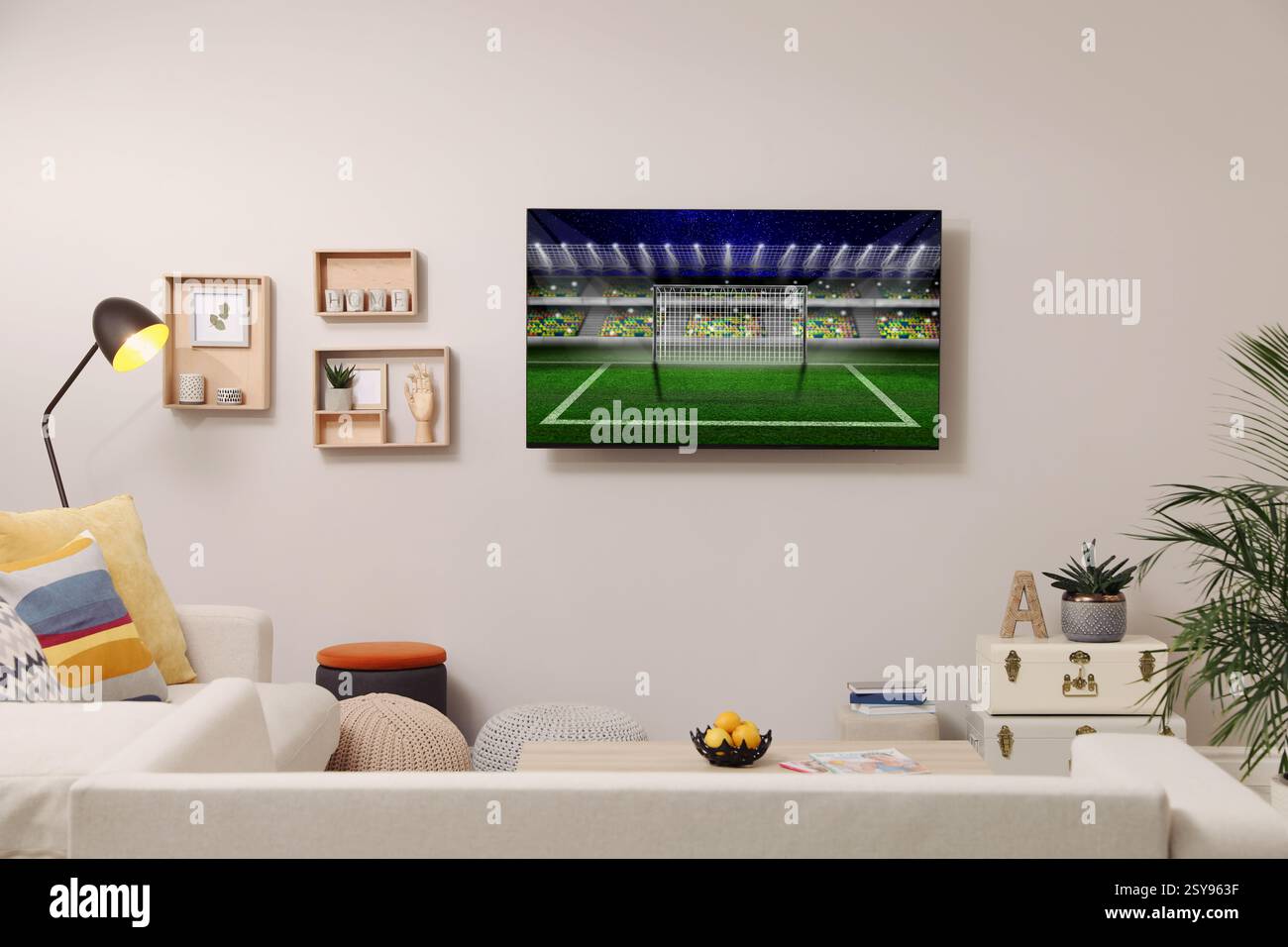 Soccer game playing on TV set in room Stock Photo - Alamy