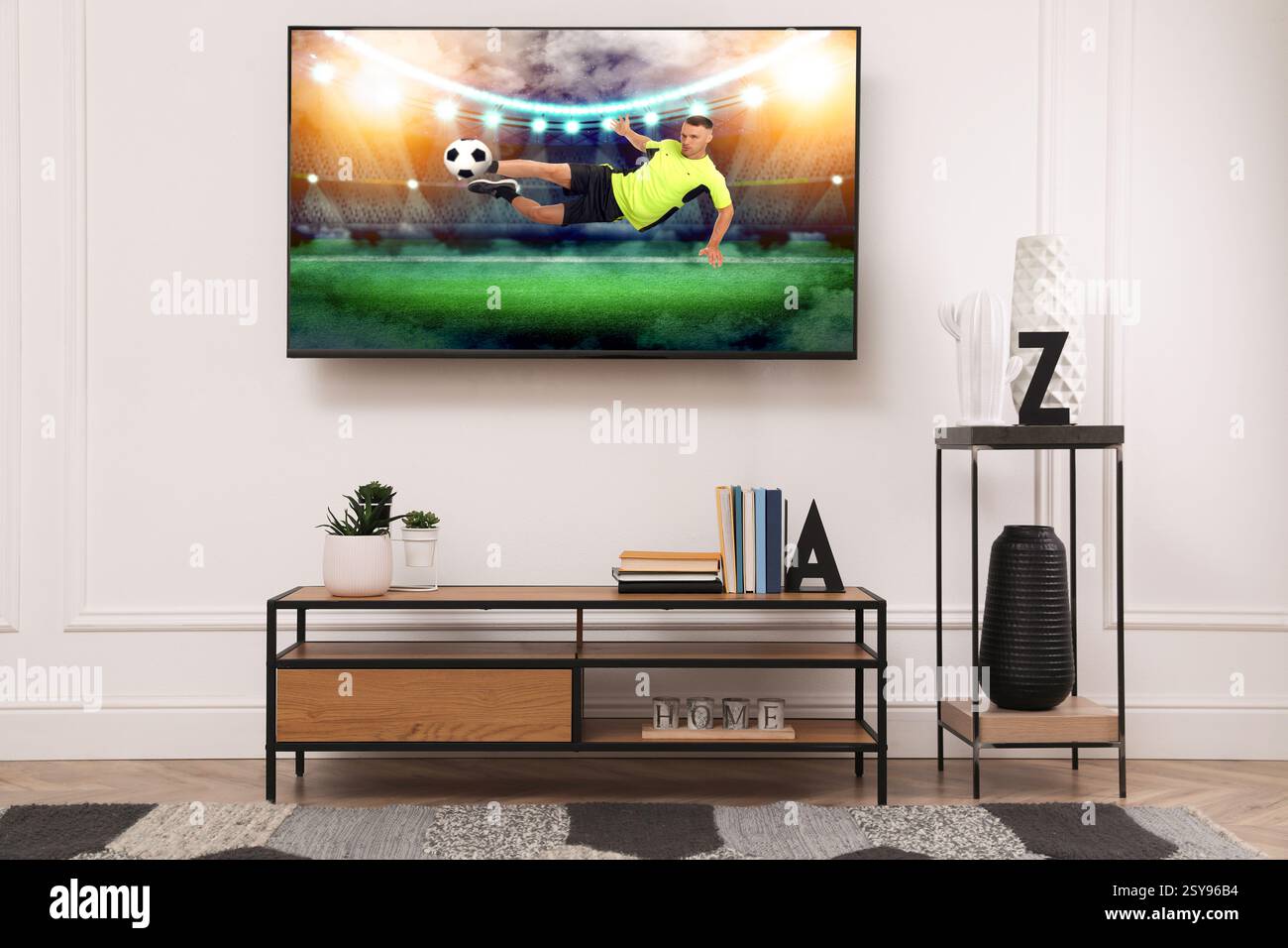 Soccer game playing on TV set in room Stock Photo - Alamy