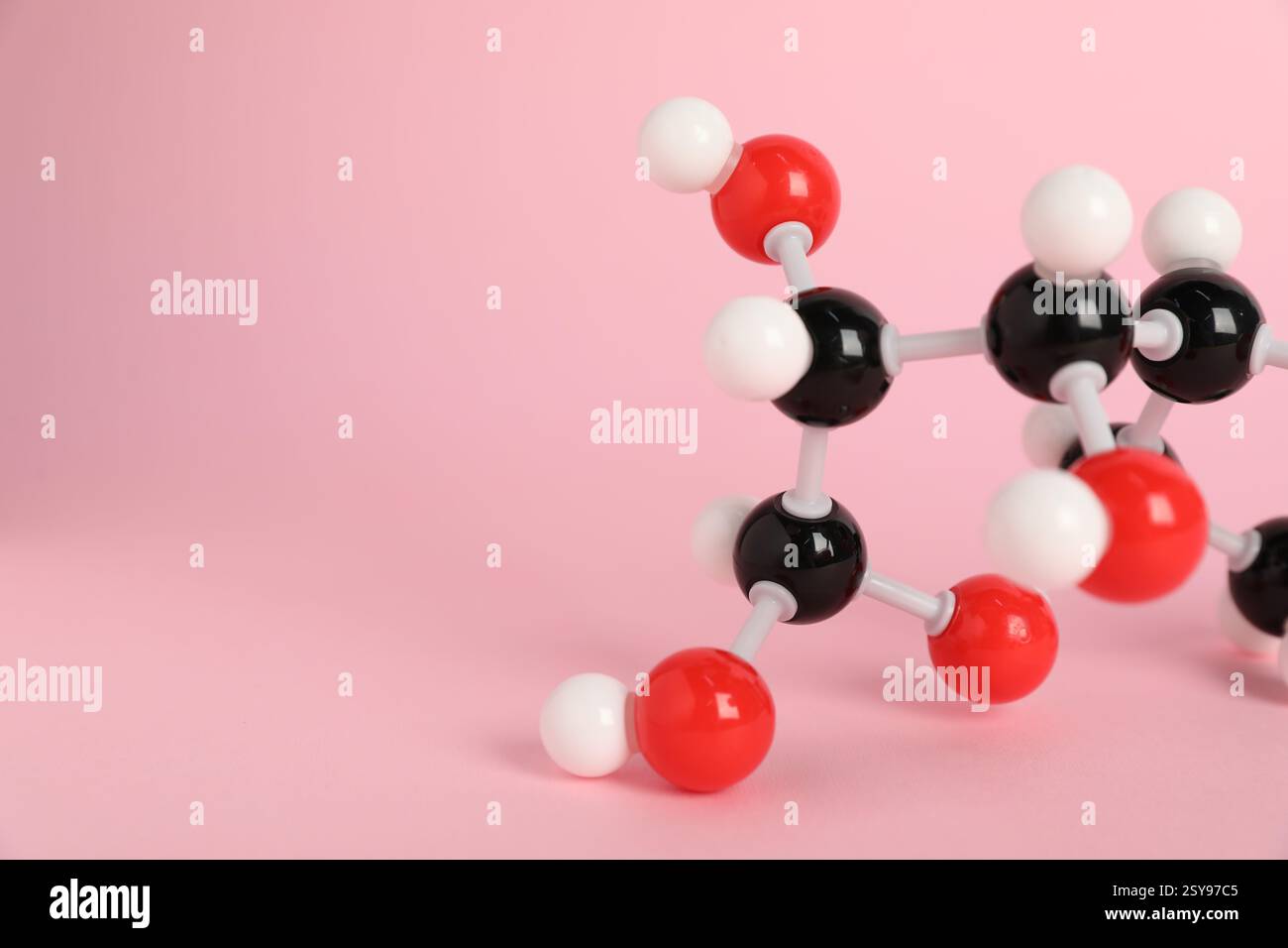 Molecule of glucose on pink background, closeup and space for text ...
